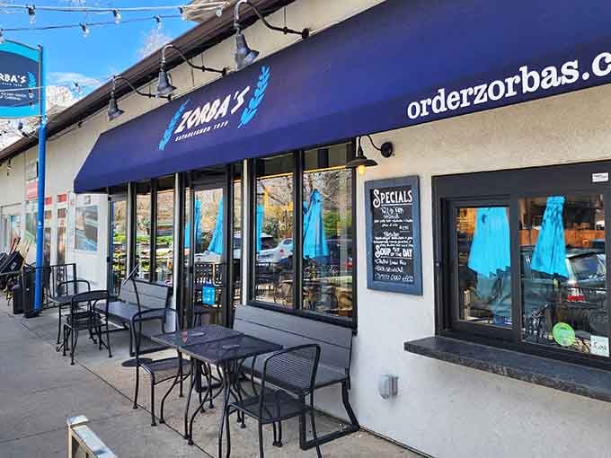 That blue awning isn't just decoration&mdash;it's a beacon calling you to Mediterranean bliss in a Denver strip mall.