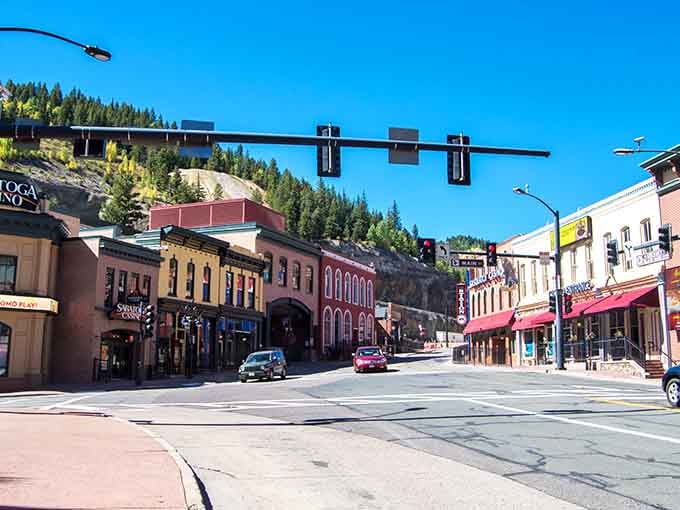 Pine-covered mountains tower over colorful storefronts, creating a backdrop Vegas could never duplicate no matter how hard it tried.