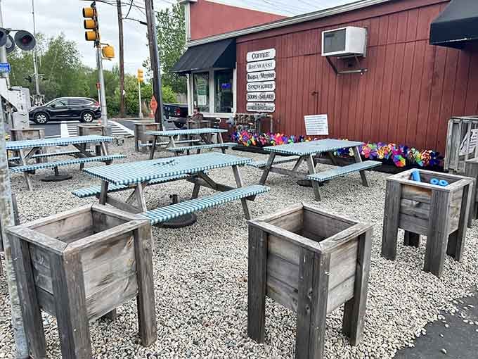 Outdoor seating with colorful umbrellas and flower boxes means your bagel comes with a side of fresh air.