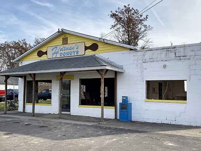 The original signage proves that sometimes the best things come in the most unassuming packages, yellow trim and all.