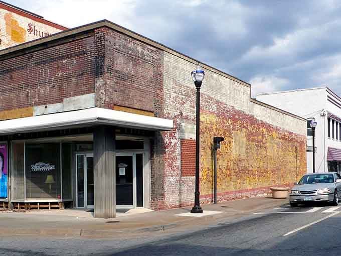 These weathered brick facades tell decades of stories, standing proud like veterans who've earned every wrinkle and scar.