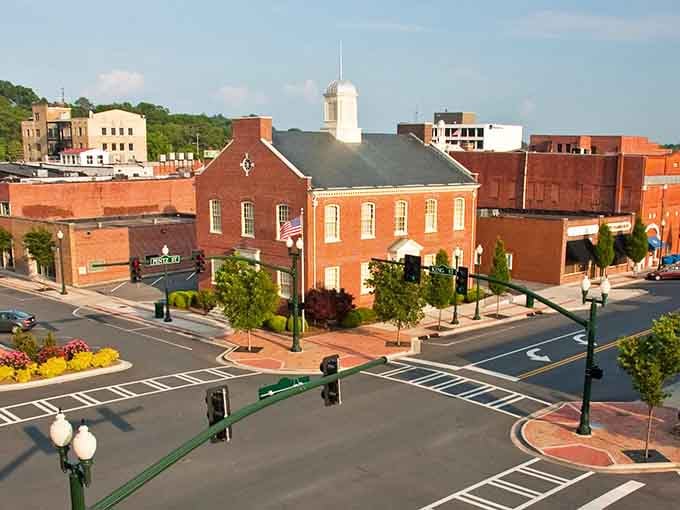 That historic red brick courthouse anchors a downtown where parking spots outnumber your monthly rent anxieties considerably.