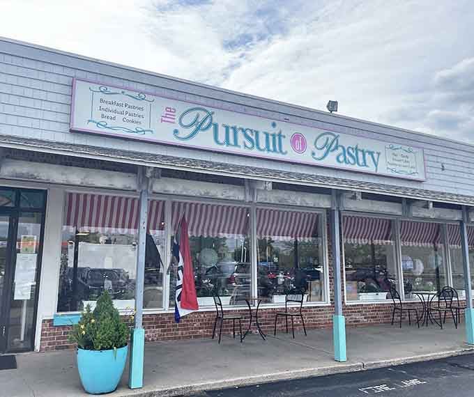 Those cheerful striped awnings are practically waving you inside for butter-laden treasures and carb-fueled happiness.