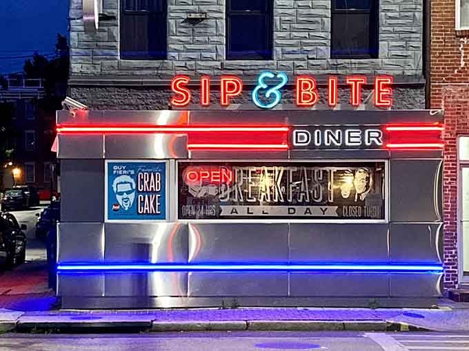 That neon glow isn't just signaling breakfast, it's broadcasting hope to hungry souls wandering Baltimore's streets at midnight.