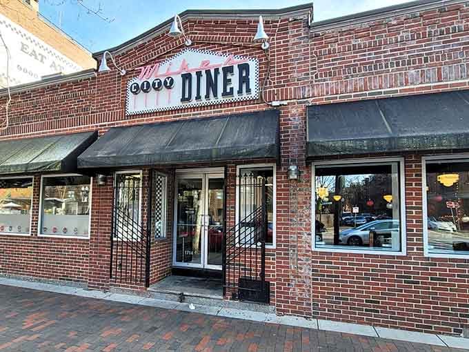 That classic brick facade and checkered awning signal one thing: serious breakfast is about to happen inside.