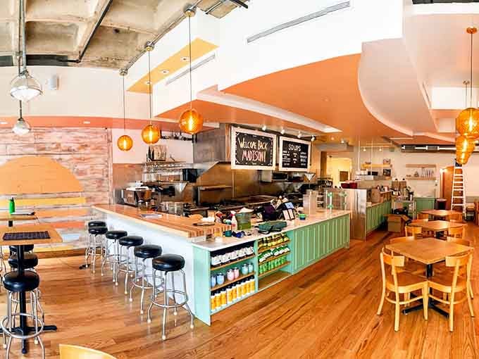 That mint green counter and those golden pendant lights create a breakfast atmosphere that's equal parts retro charm and modern sophistication.