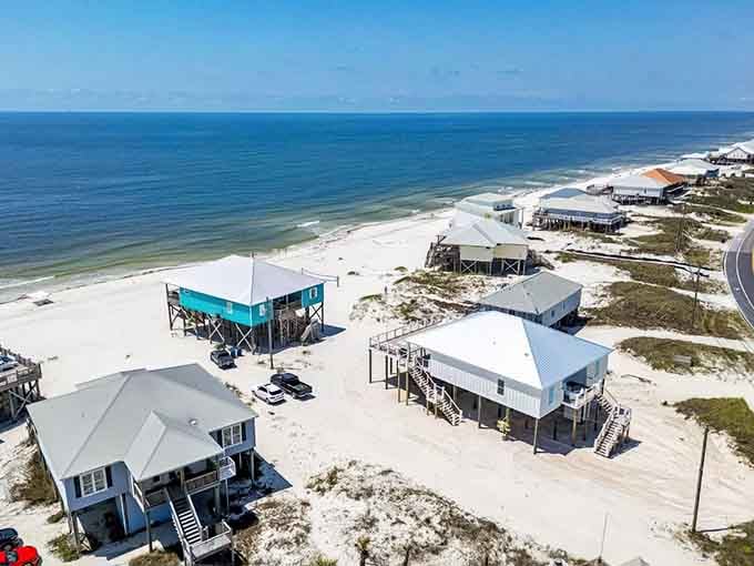 Beach houses on stilts line the shore like they're waiting for the next storm to prove they were right all along.