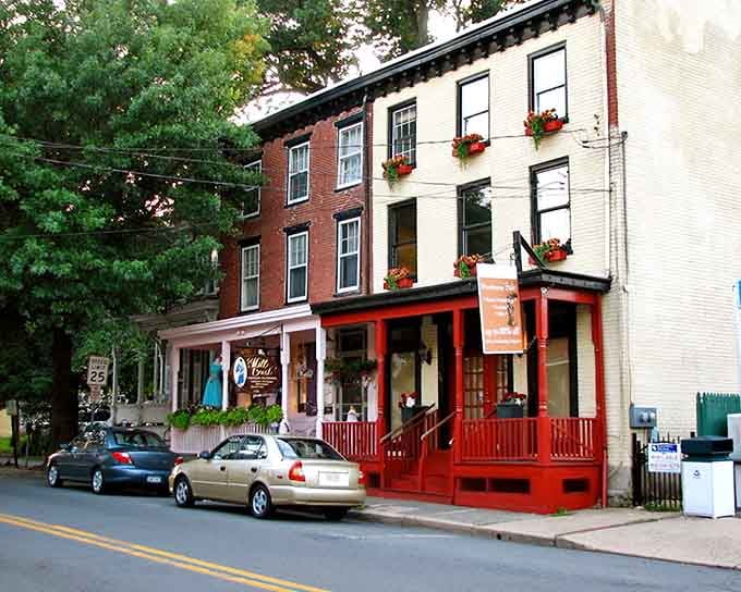 Window boxes overflow with flowers like someone's grandmother went absolutely wild at the garden center, and bless them for it.