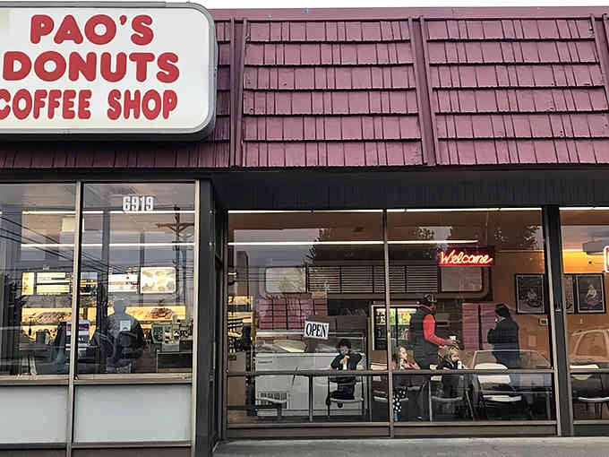 The cheerful storefront promises fresh donuts and hot coffee, two things that make mornings worth experiencing.