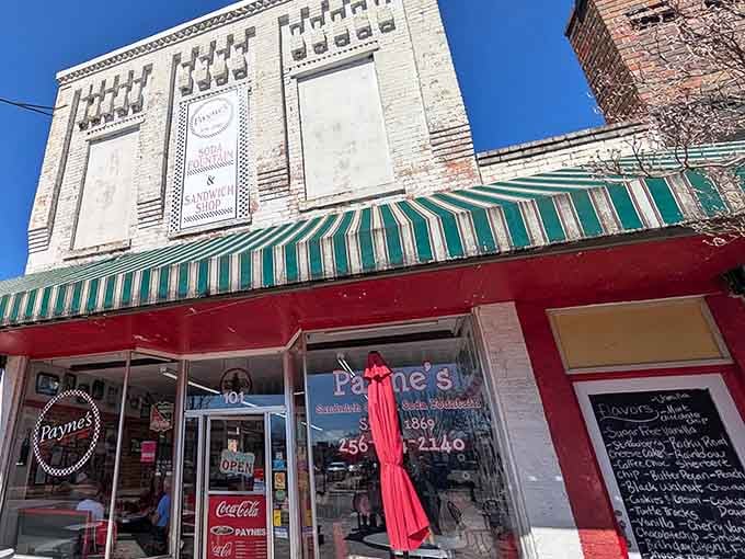 That striped awning isn't just decoration; it's a portal to an era when diners were America's living rooms.