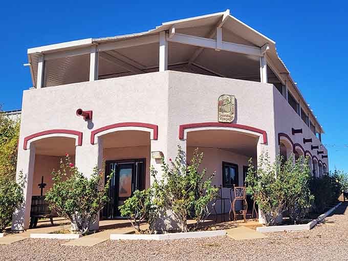 The building practically glows with Southwestern charm, like someone designed a wine lover's desert oasis with perfect arches.