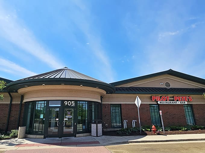 That distinctive curved entrance isn't just architectural flair, it's your gateway to watching million-dollar machines while eating affordable comfort food.