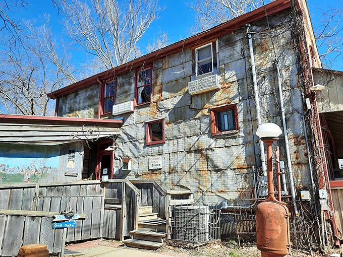 The rustic exterior practically whispers tales of travelers past, each weathered board holding decades of Indiana history within.