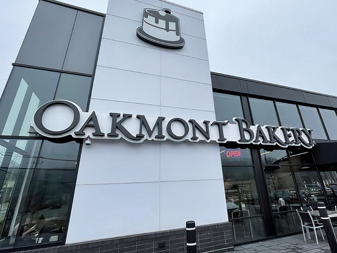 That iconic cake logo beckons like a lighthouse for the carb-obsessed, promising sweet salvation within those modern walls.