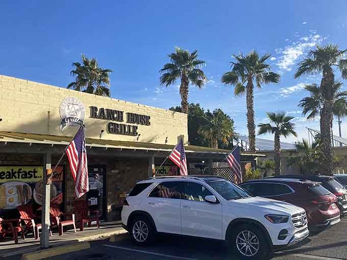 Palm trees and American flags frame this neighborhood treasure where the parking lot tells you everything about the food inside.