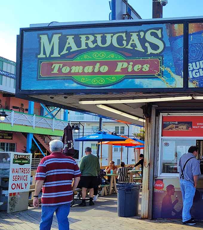 That classic boardwalk sign promises tomato pie perfection, and spoiler alert: it absolutely delivers on every delicious word.