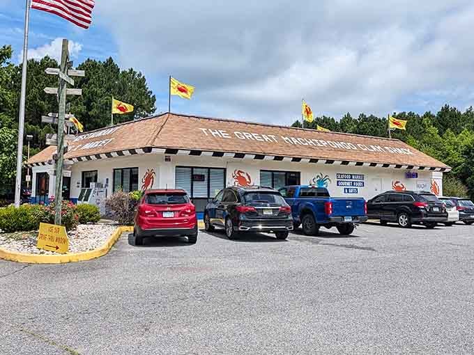 Colorful crab flags wave hello while the parking lot whispers promises of the seafood feast awaiting inside.