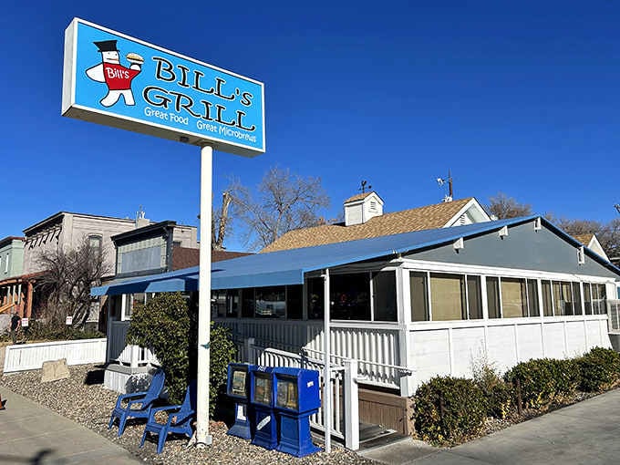 That retro sign and those cheerful blue chairs outside are basically screaming "come eat something delicious and regret nothing."