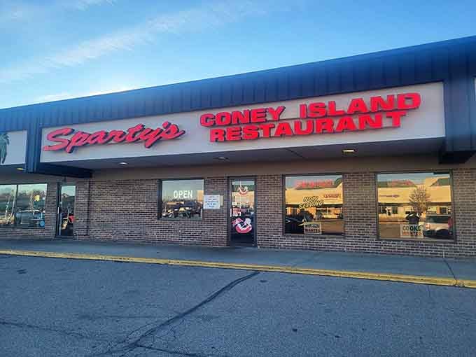 That cheerful sign knows something you don't—legendary coney dogs await inside.
