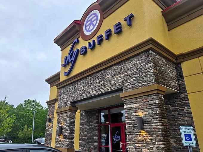 The yellow exterior and stacked stone facade promise the kind of feast that requires elastic waistbands and zero regrets.