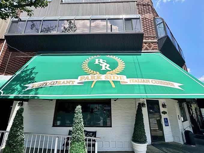 Classic white brick and that signature emerald canopy make this corner of Corona look like it was airlifted from a charming Italian neighborhood.