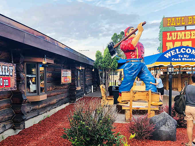 That giant lumberjack statue out front isn't just for show—it's a promise of the oversized hospitality waiting inside.