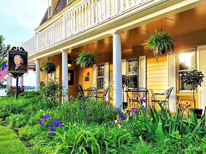 Golden porch lights and blooming gardens welcome guests at the historic Robert Morris Inn in Maryland, where timeless charm meets waterfront comfort.