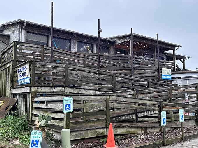 That weathered wooden staircase isn't just rustic decor; it's earned every splinter through decades of devoted diners climbing toward seafood heaven.
