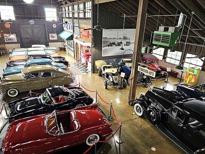 Chrome gleams under barn rafters where automotive dreams from multiple eras gather like old friends at a reunion.