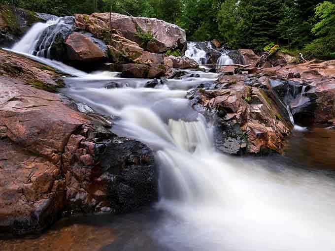 Those rust-colored rocks have been here longer than anyone's complaining about their back, which is really saying something.