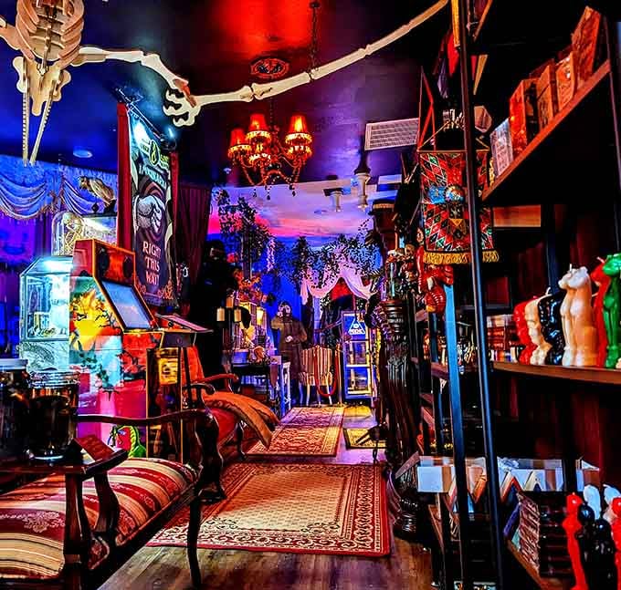 That dramatic interior corridor bathed in moody blue and red lighting sets the perfect atmospheric tone immediately.