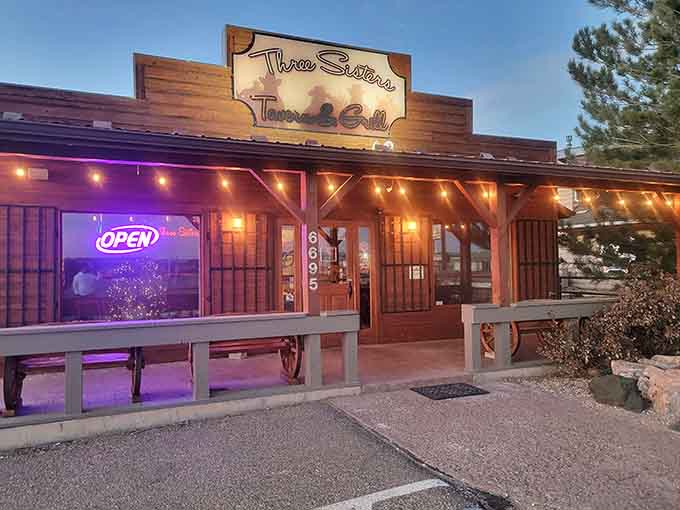 Evening lights transform Three Sisters Tavern & Grill into a glowing beacon for hungry travelers and locals alike.