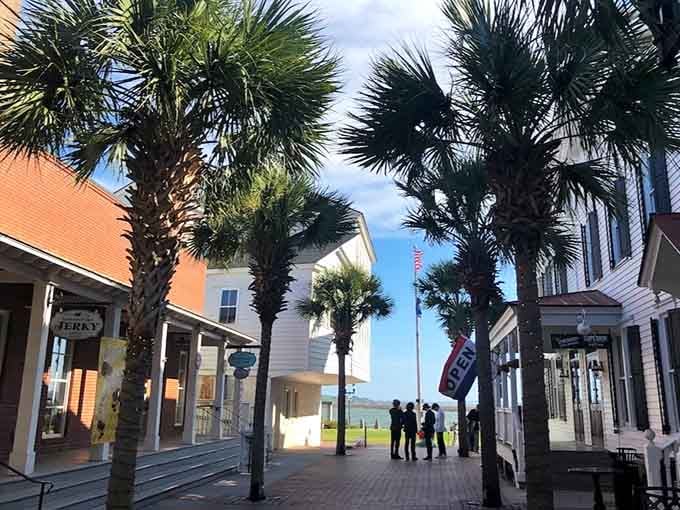 Those palmetto palms frame the view perfectly, creating a natural corridor to adventures waiting just beyond the brick walkway.