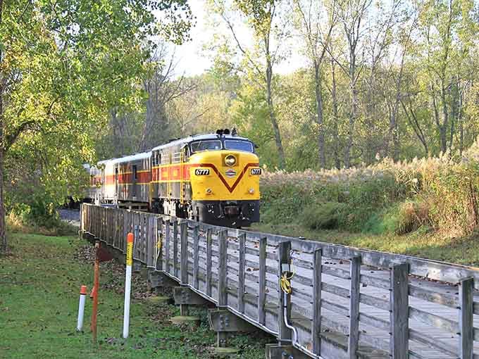 That vintage locomotive gliding through the valley looks like it escaped from a Norman Rockwell painting, diesel engine and all.