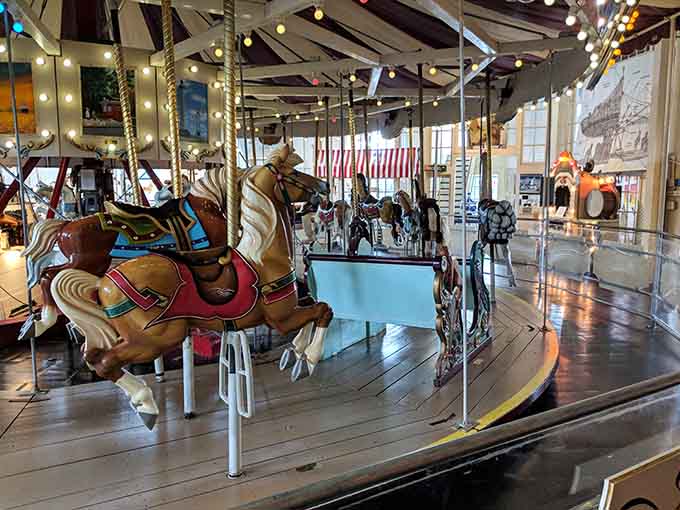 Hand-carved horses frozen mid-gallop, waiting patiently for their next adventure around the ring.