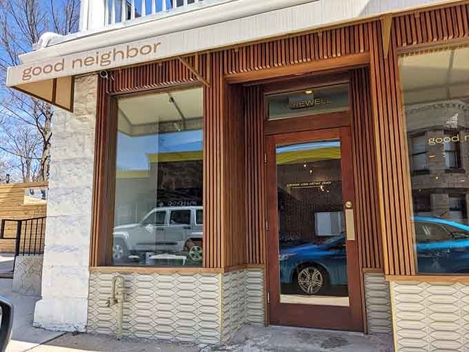 Those warm wood slats and textured stone panels whisper "come in, stay awhile" louder than any welcome mat ever could.