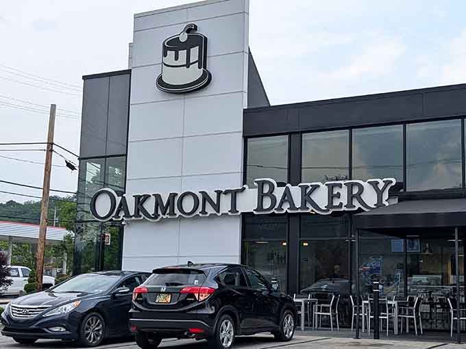 That iconic cake logo beckons like a lighthouse for the carb-obsessed, promising sweet salvation within those modern walls.