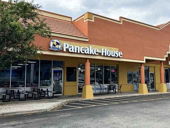 That cheerful yellow and coral exterior is like a beacon calling you home to breakfast paradise.
