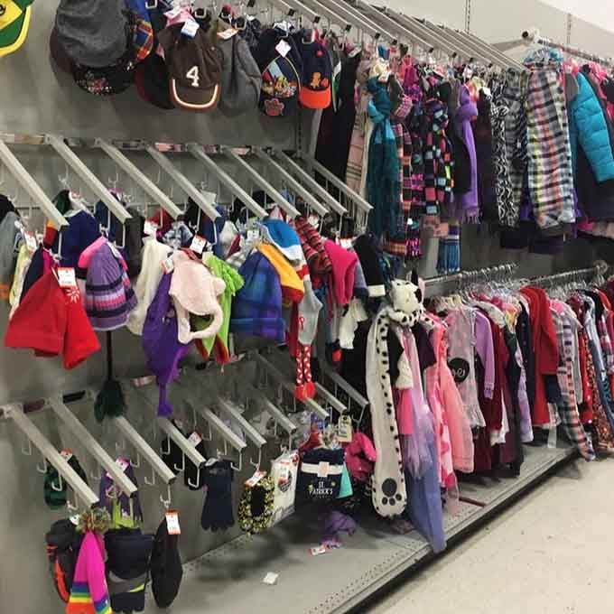 Children's clothes organized by size and color, because even thrift shopping deserves some civilized structure.