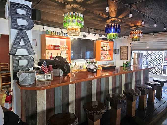 The bar area combines rustic charm with Southern hospitality, creating the perfect spot for pre-dinner drinks and conversation.