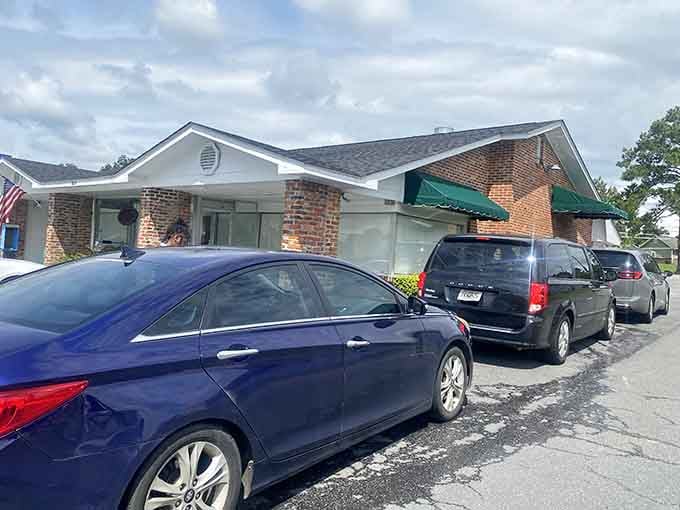 That classic lowrider parked outside the brick building creates a scene straight from American Graffiti, minus the drag racing.