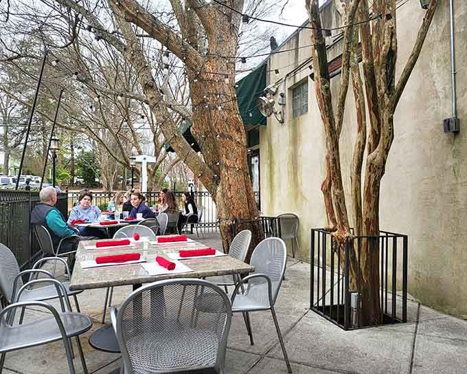 Outdoor seating under the trees makes every meal feel like a European vacation without the jet lag.