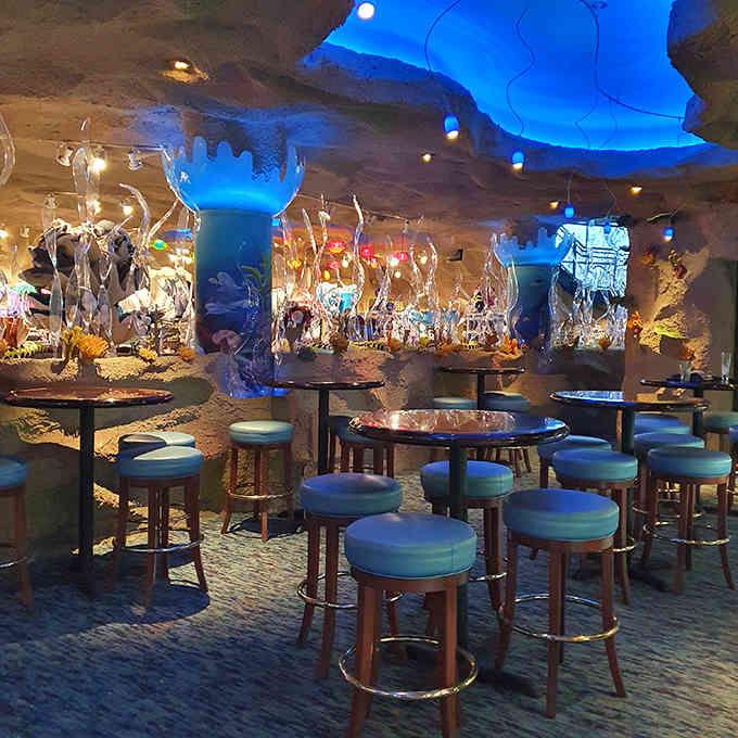 The bar area features intimate seating where you can sip cocktails while stingrays cruise past overhead.