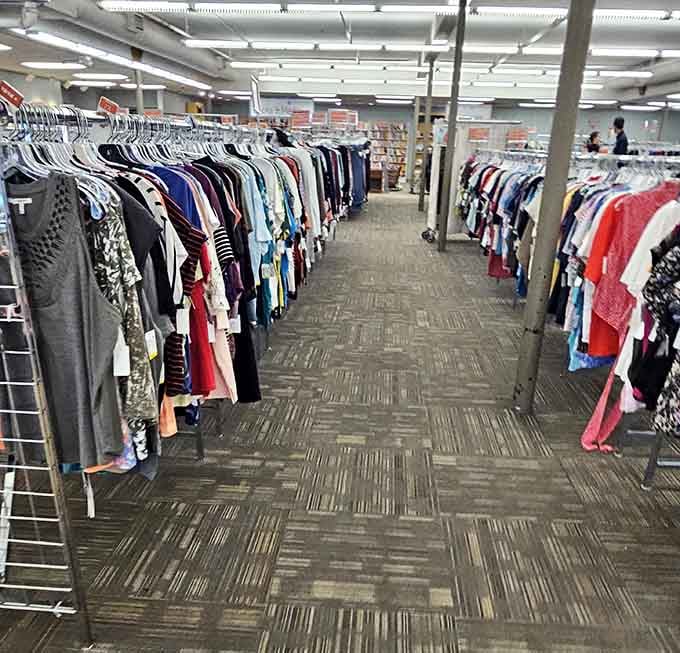 Endless aisles of clothing stretch into the distance, a fabric maze where time loses all meaning.