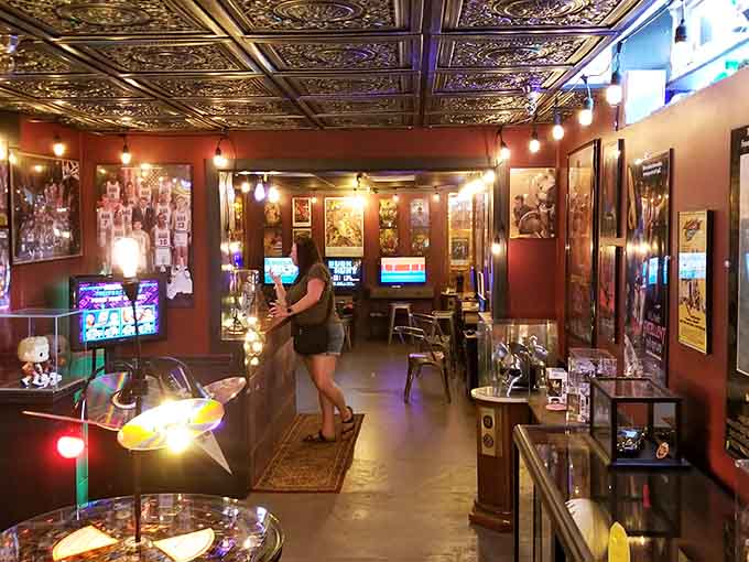 Decorative tin ceiling tiles add unexpected elegance to a space dedicated entirely to electronic chaos and fun.