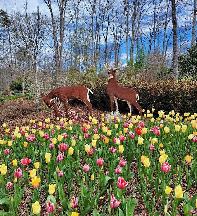 Deer sculptures stand sentinel among tulips, creating a scene so peaceful you'll forget your phone exists for a moment.