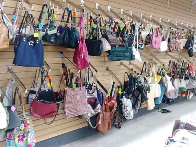A handbag wall of fame where every purse gets its moment to shine, regardless of its previous life.
