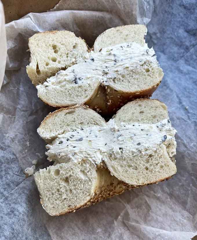 Garlic herb cream cheese spread thick on a fresh bagel: this is what happiness looks like in carbohydrate form.