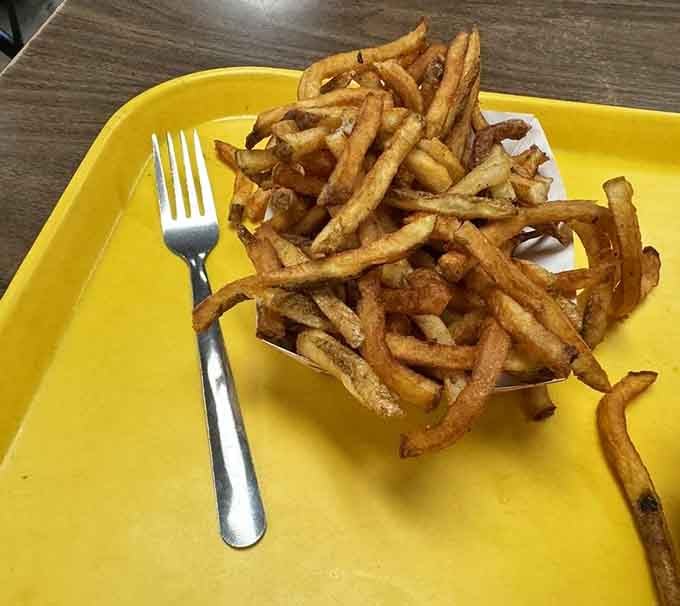Golden, crispy fries stacked like a delicious Jenga tower that you'll happily demolish one piece at a time.