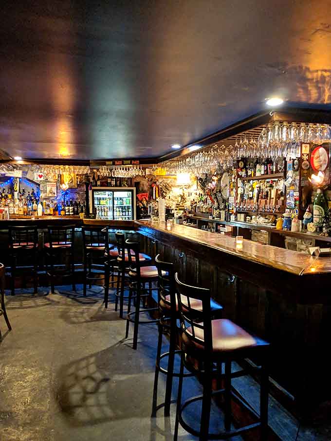 The bar glows with ambient lighting and fully stocked shelves, ready to mix your royal cocktail.